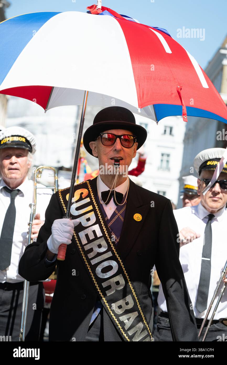 London, UK. 11 May, 2025. The leader of the Superior Brass Band at the ...