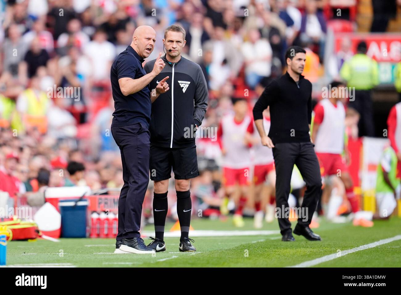 Liverpool manager Arne Slot (left) speaks to fourth official Craig ...