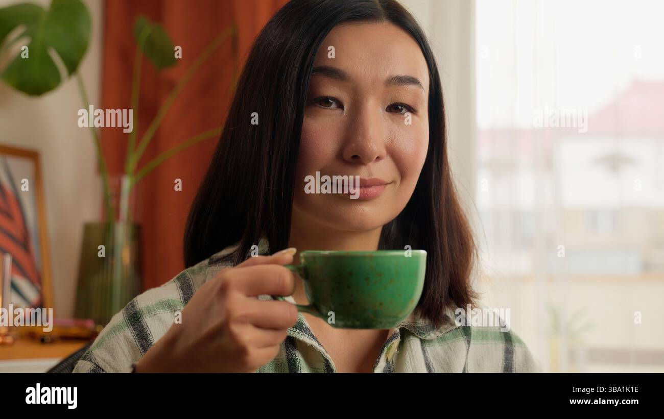 Portrait Asian Korean Chinese Japanese woman girl female home enjoying drinking aroma tea coffee ...