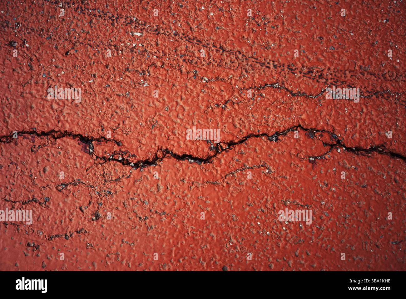 Red asphalt texture with black crack, material details Stock Photo - Alamy