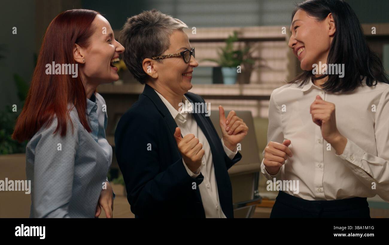 Happy multicultural women celebrate victory winning females dance ...