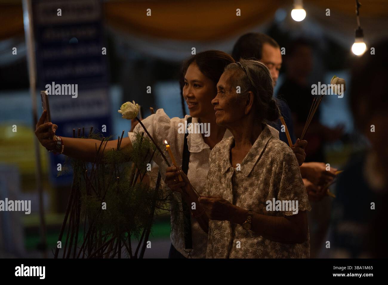 Buddhists sets light candles and pray during walk clockwise around the ...