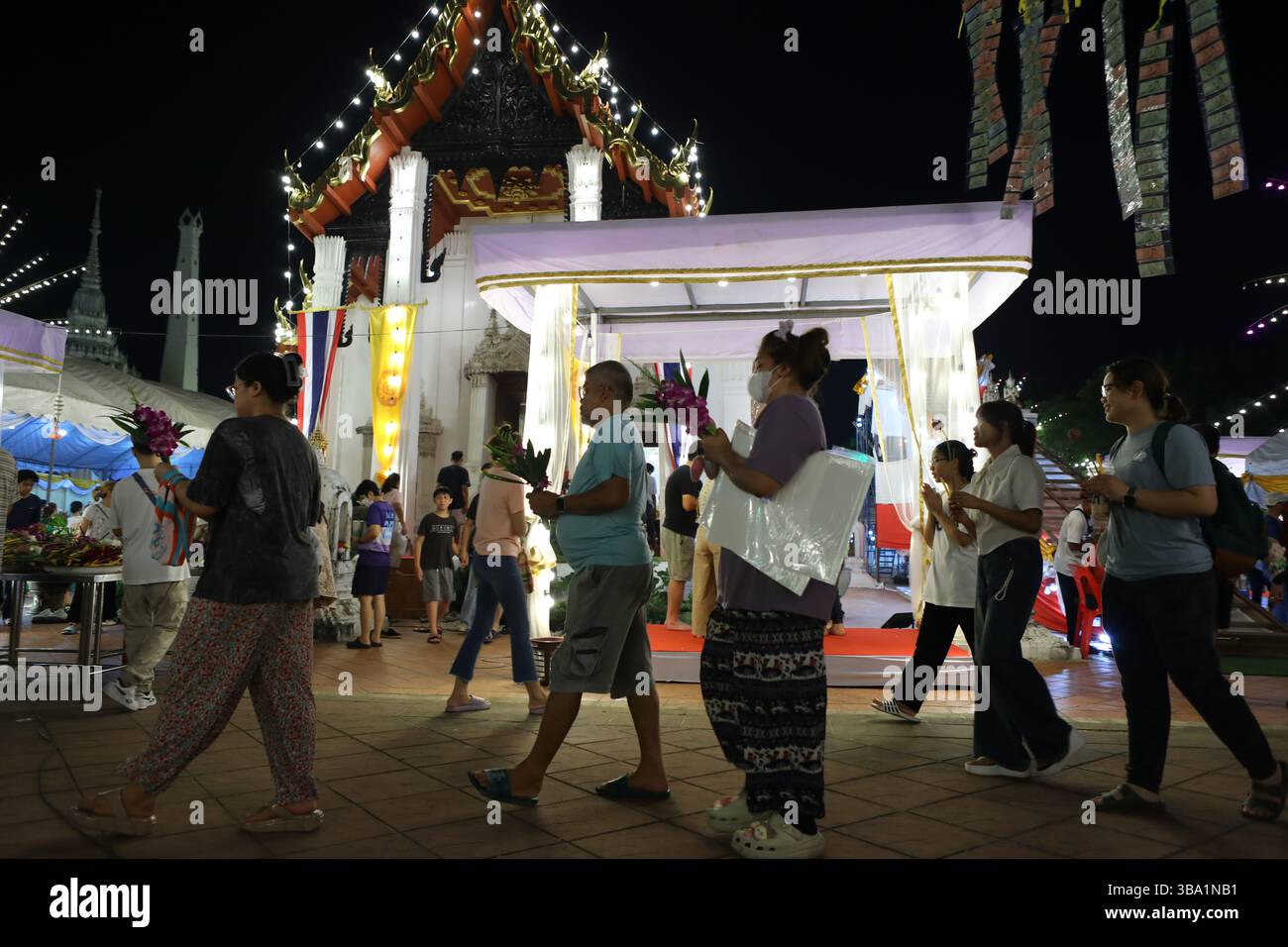 Buddhists sets light candles and pray during walk clockwise around the ...