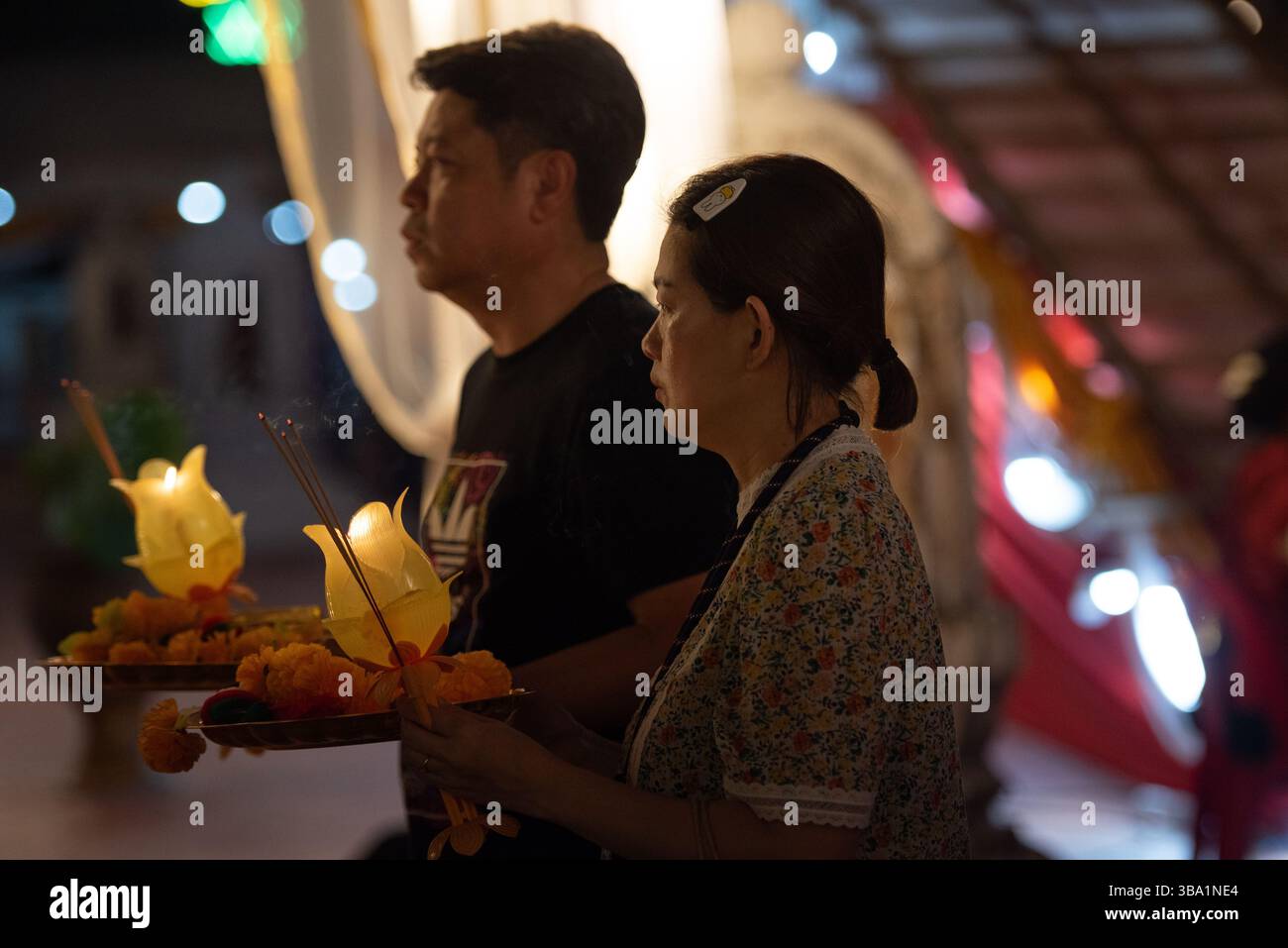 Buddhists sets light candles and pray during walk clockwise around the ...