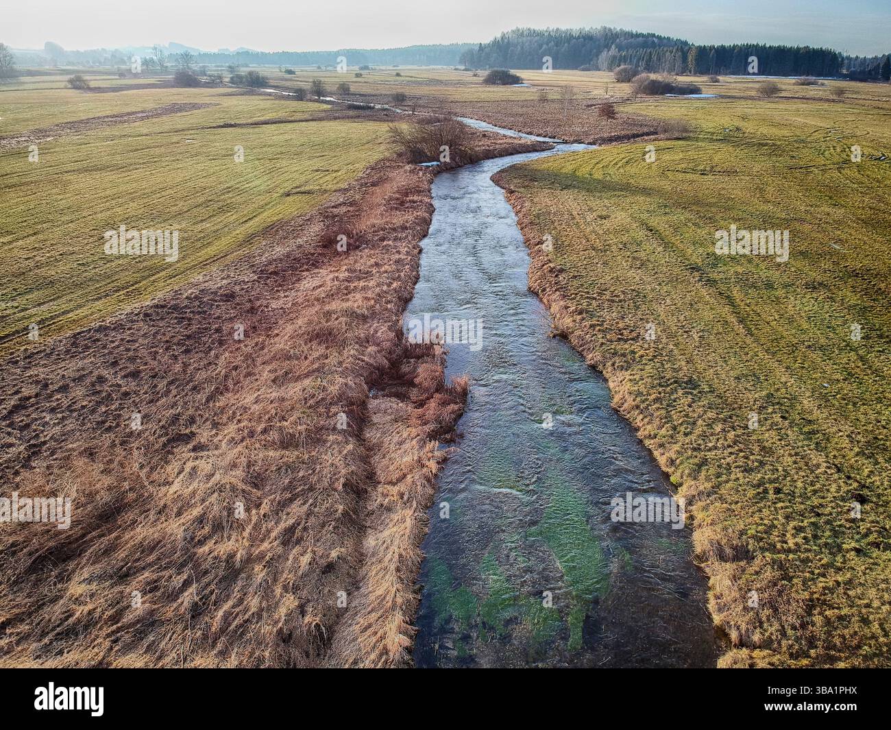 River runs through a field of grass Stock Photo - Alamy