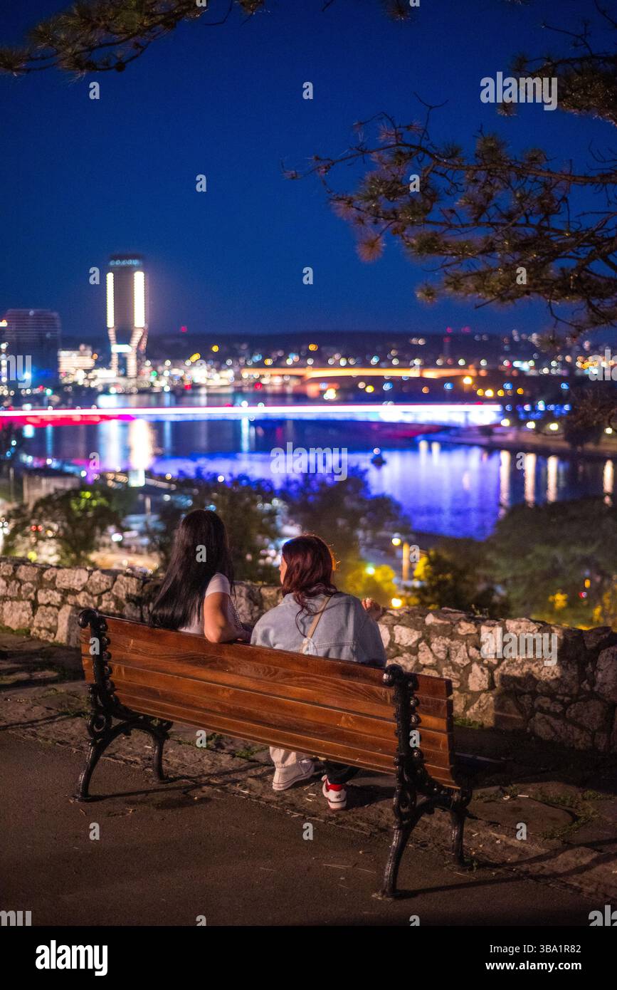 People enjoying night view from the Belgrade fortress of the Sava river ...