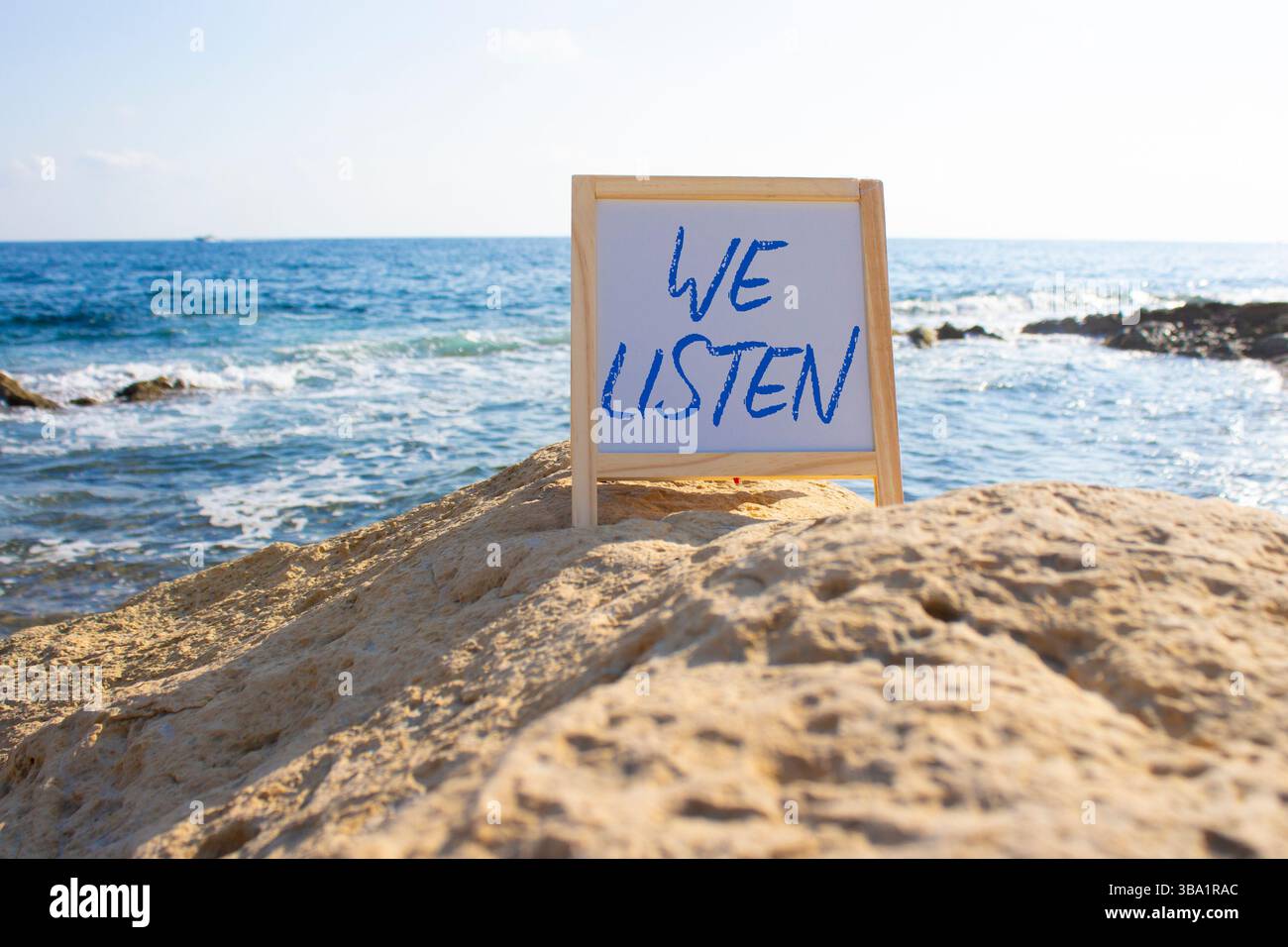 We listen symbol. Concept words We listen on white chalk background ...