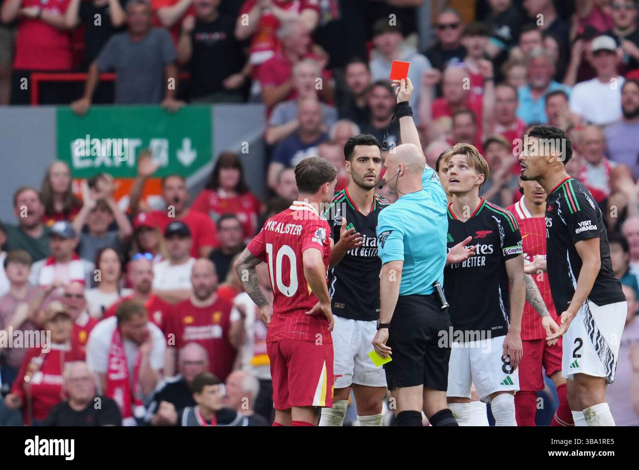 Referee Anthony Taylor shows a red card to Arsenal's Mikel Merino ...