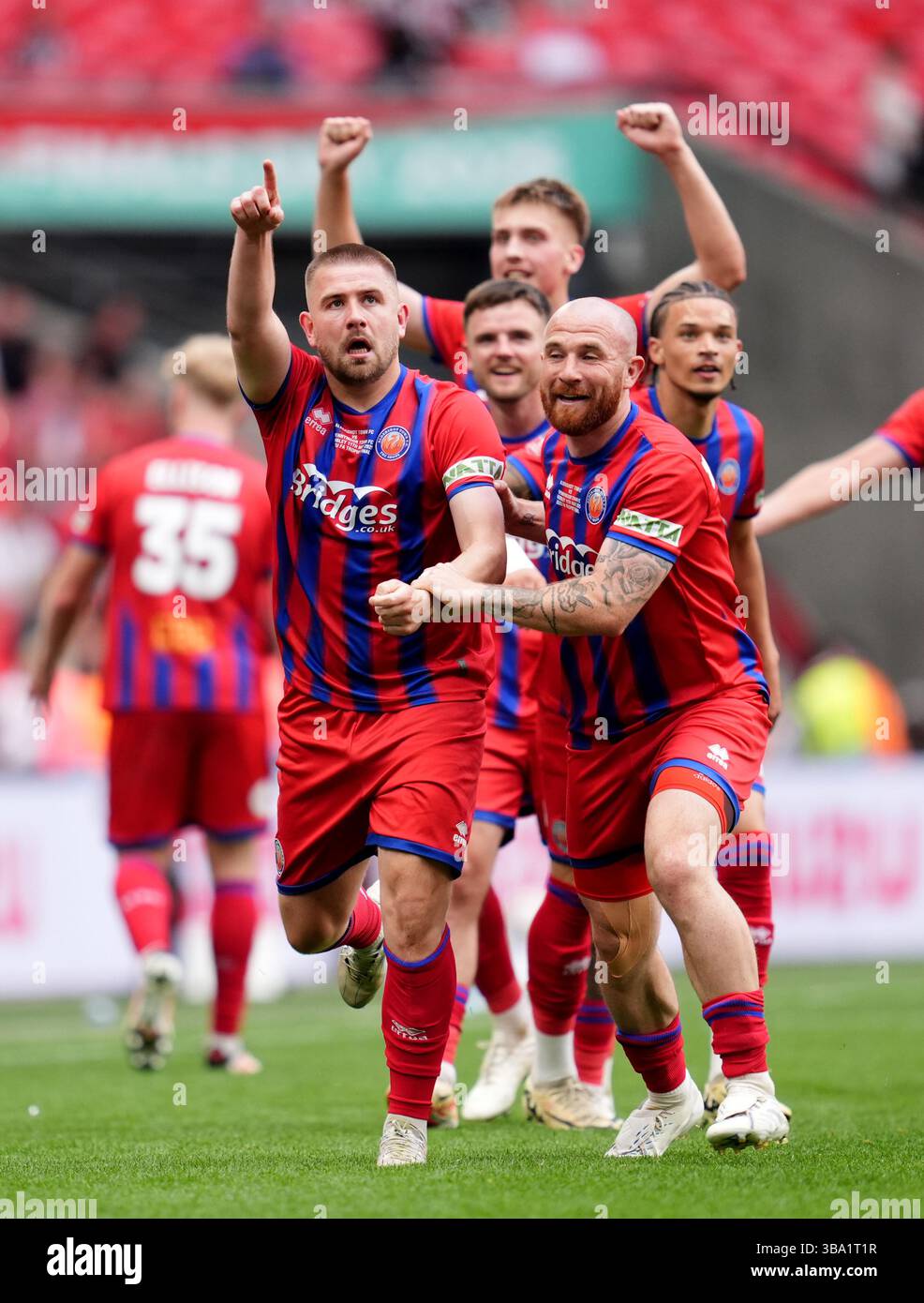 Aldershot Town's Josh Barrett (left) celebrates with his team mates ...