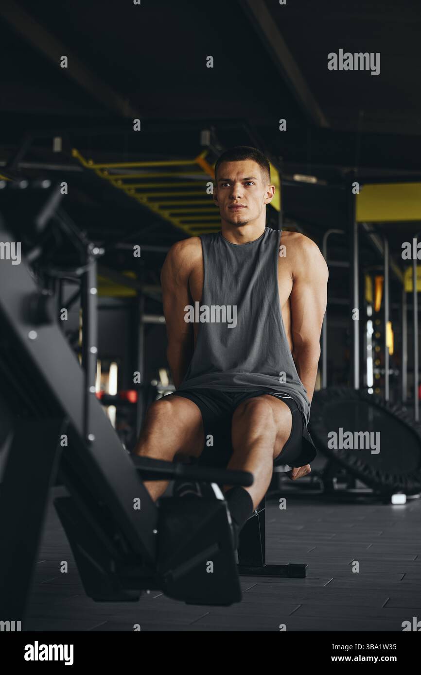 Vertical photo of muscular young athlete man recovering after Rowing ...