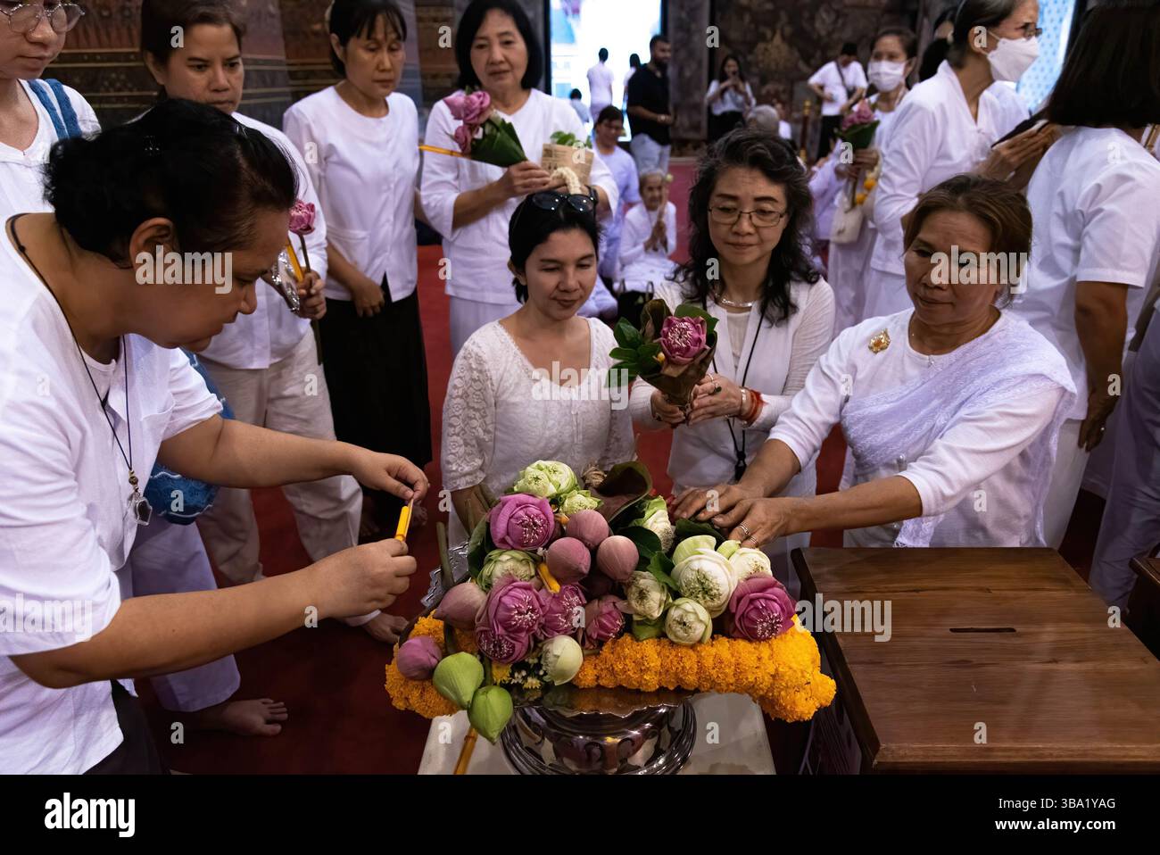 Bangkok, Thailand. 11th May, 2025. Buddhist devotees lay flowers for ...