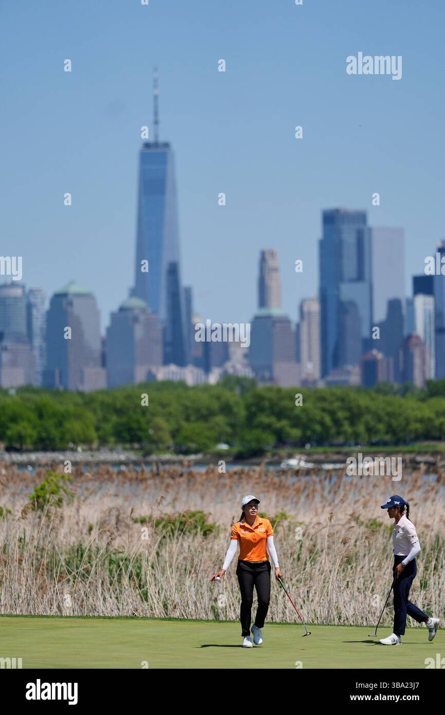 Jeeno Thitikul, left, of Thailand, and Celine Boutier, of France, walk ...