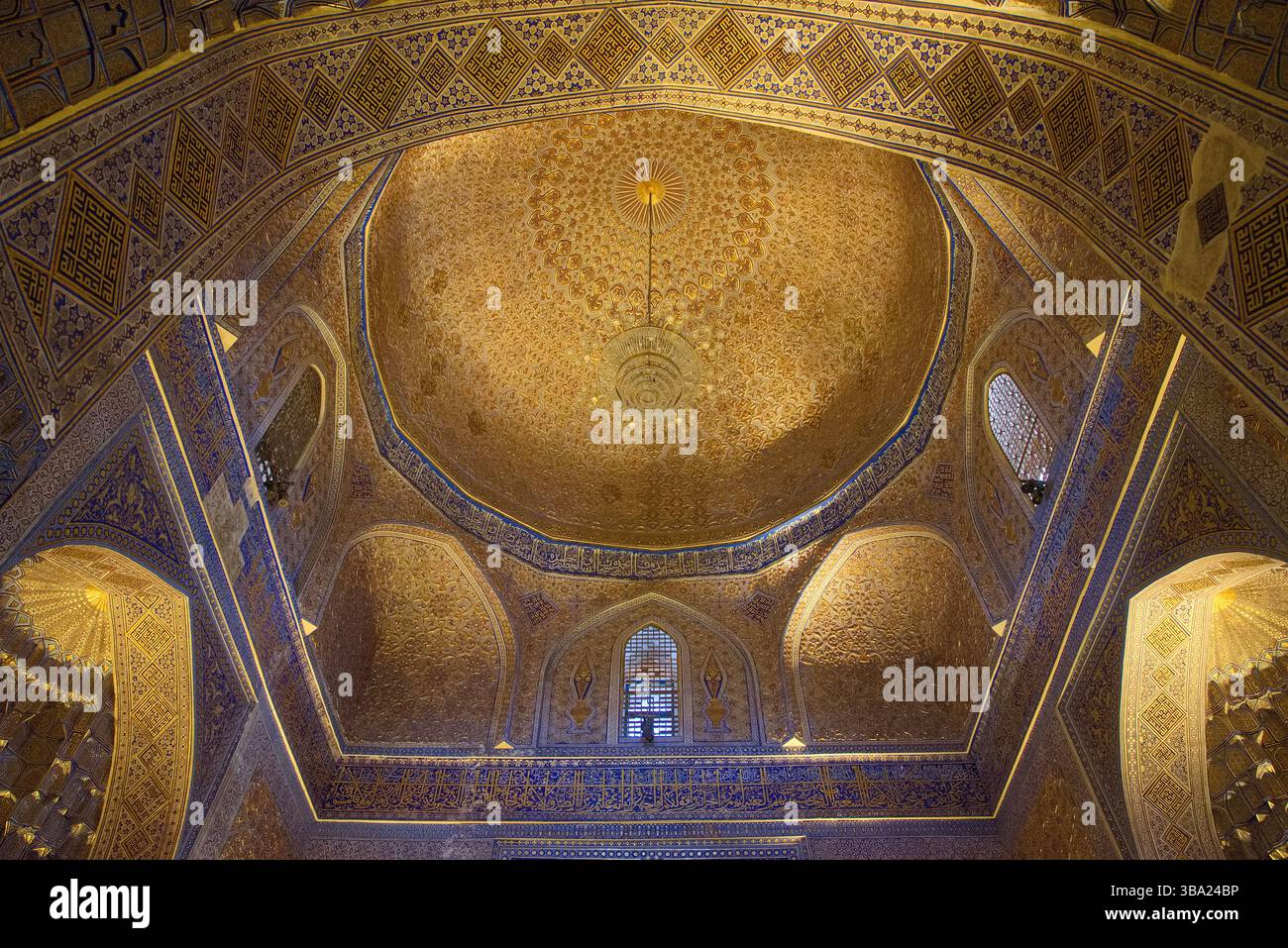 Ornate ceiling and dome of the gilded interior of the Gur Emir ...