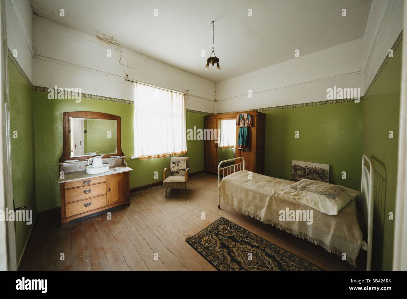 Interior of a colonial green sleeping room with bed and furnitures ...
