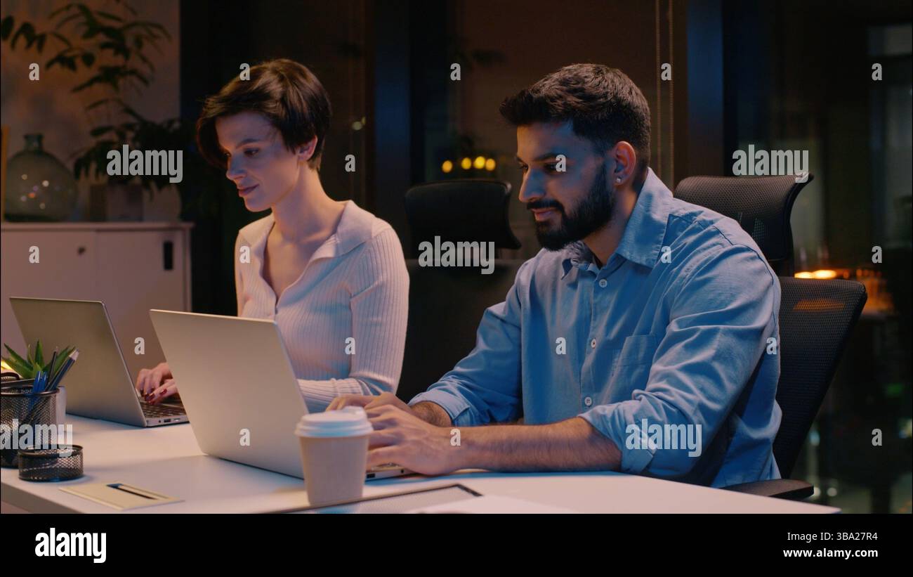Two managers typing laptops night hi-res stock photography and images ...