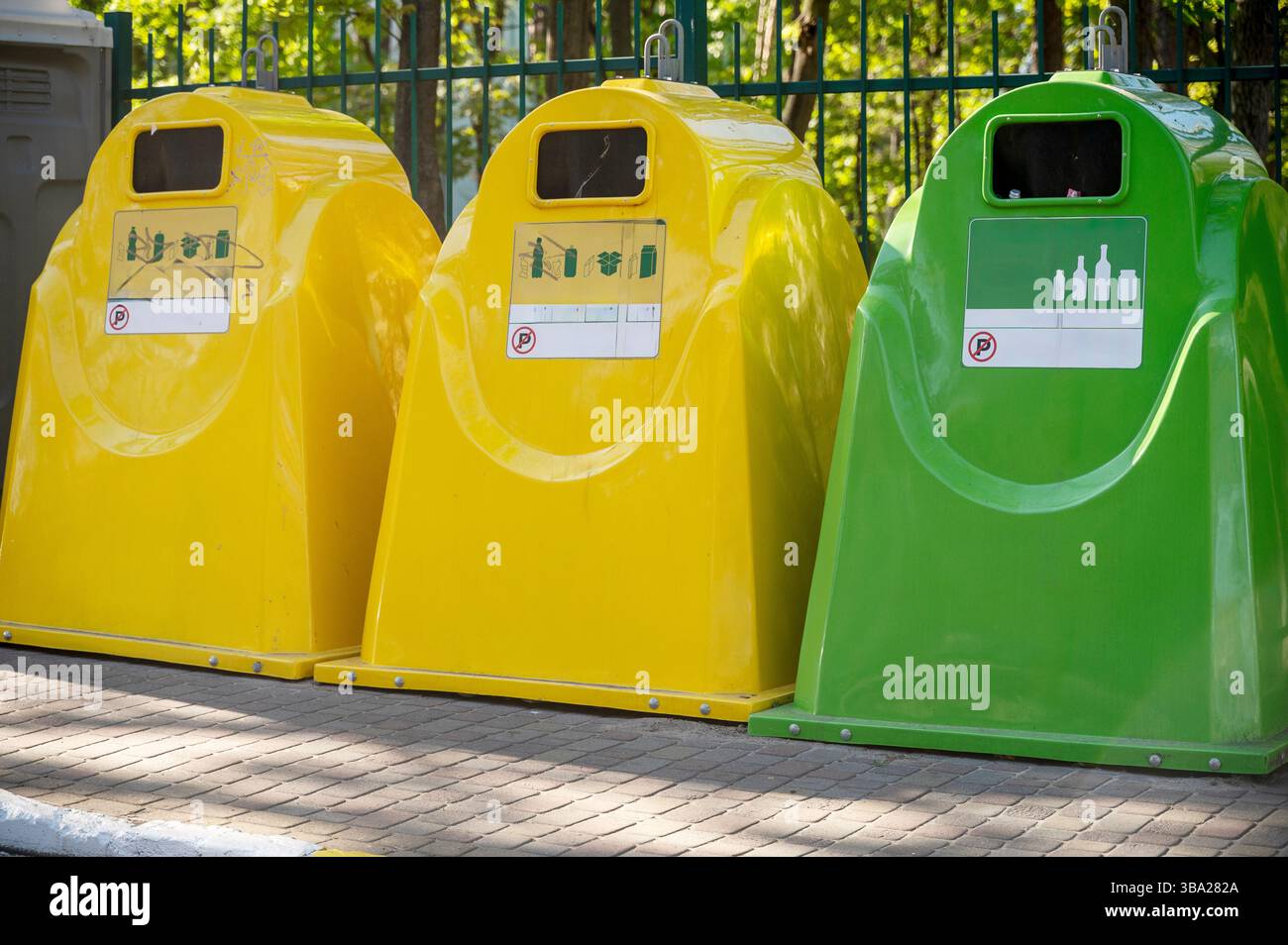 Garbage collection containers for recycling against city background ...
