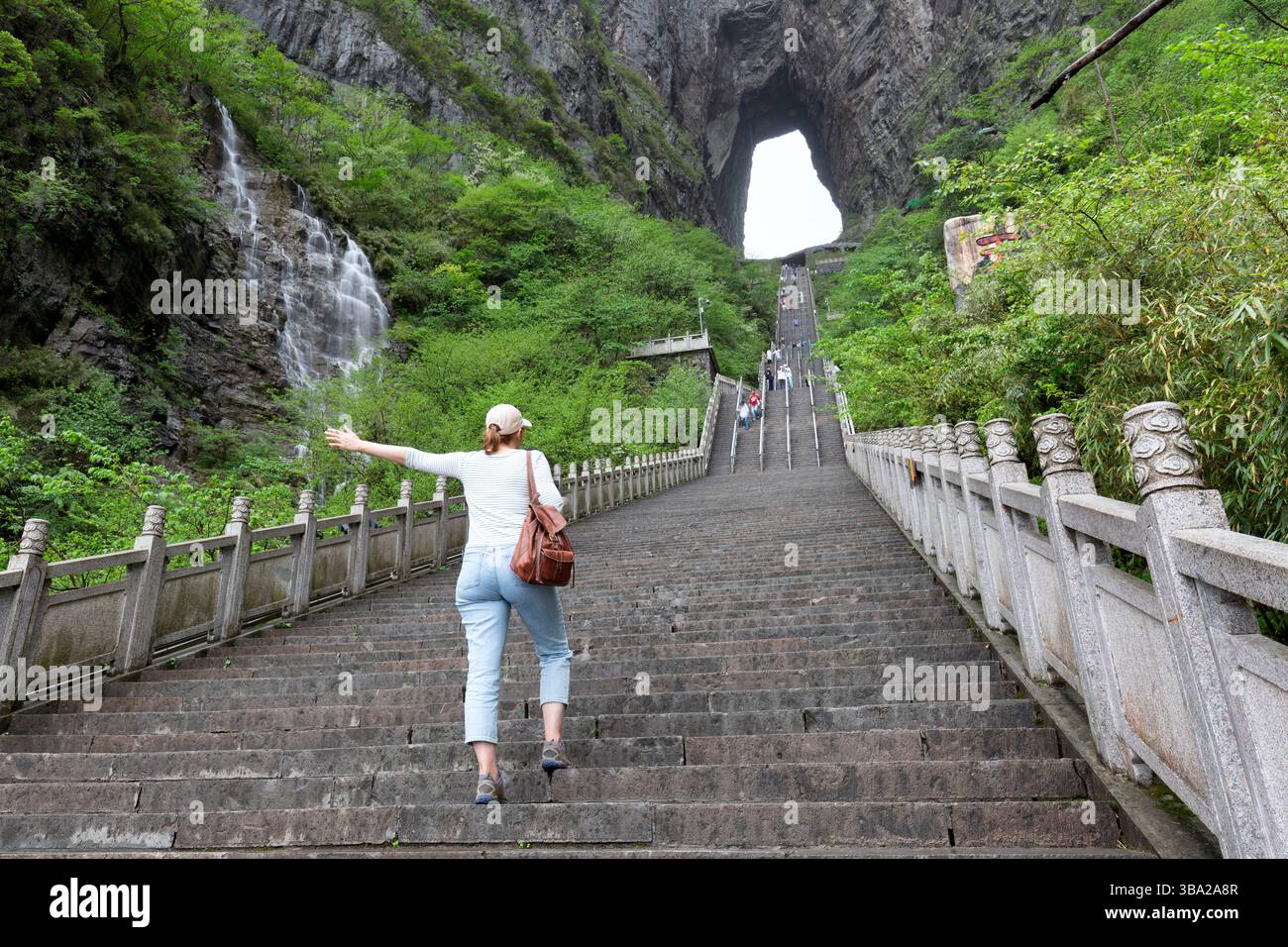 Young female tourist enjoying beautiful nature landscape with mist at ...
