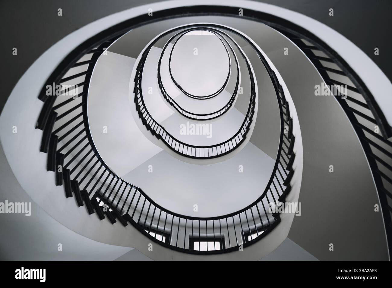 Looking deep into long spiral stair case of big building, concept photo ...