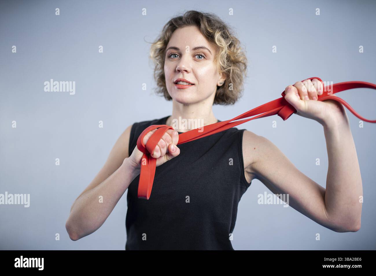Sports woman exercising with a resistance band. Slim girl in good shape ...