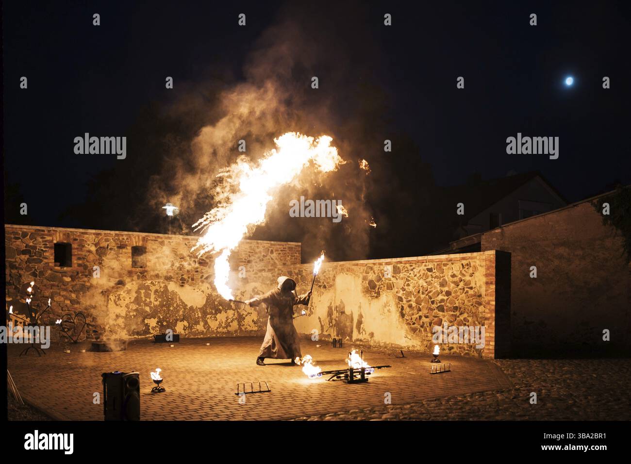 Photo of a fire show performer playing with fire Stock Photo - Alamy
