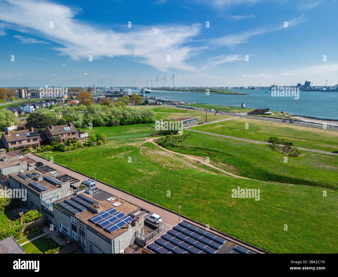 Aerial view of a coastal town with green parks, residential areas, a ...