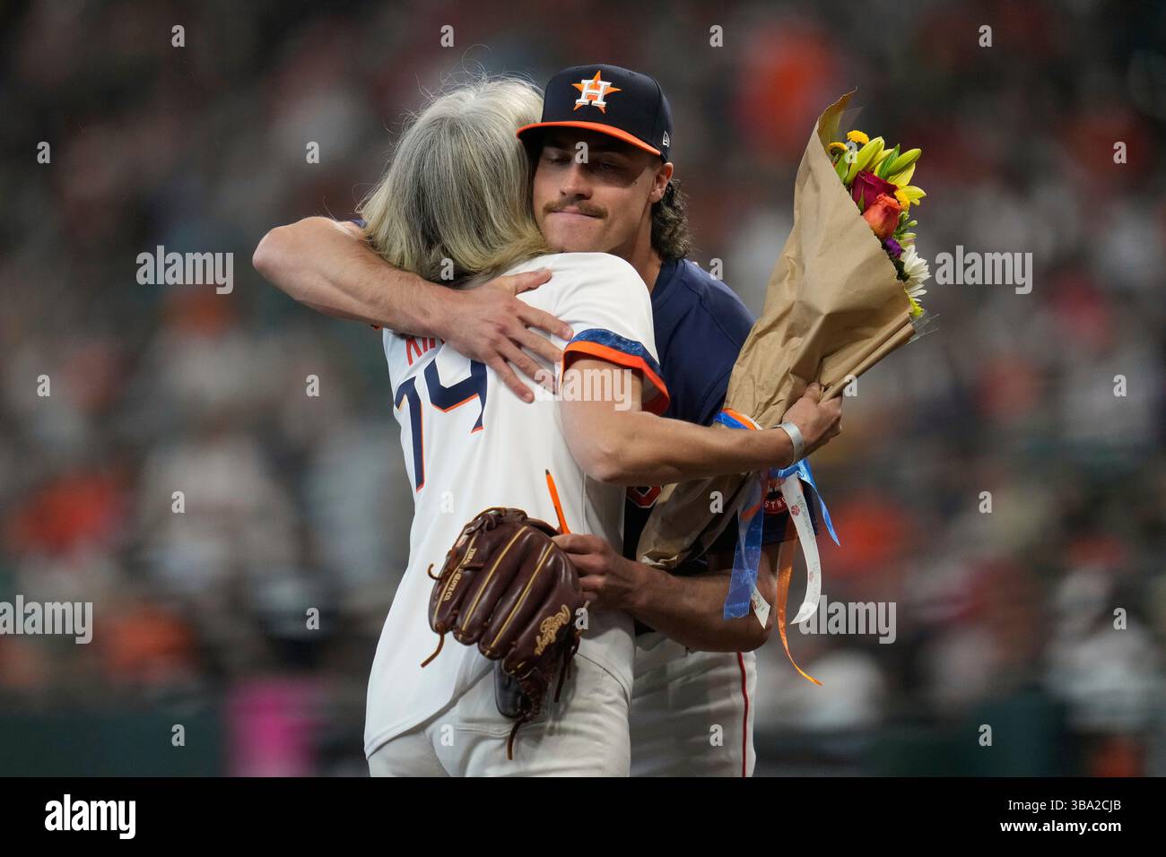 Houston Astros relief pitcher Bryan King, right, hugs his mother, Amy King, after she threw out ...