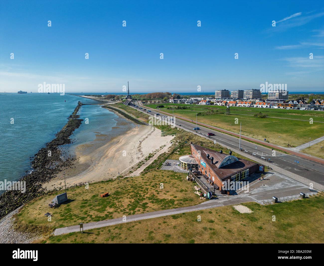 A coastal view showing a quiet seaside town with a rocky shoreline ...