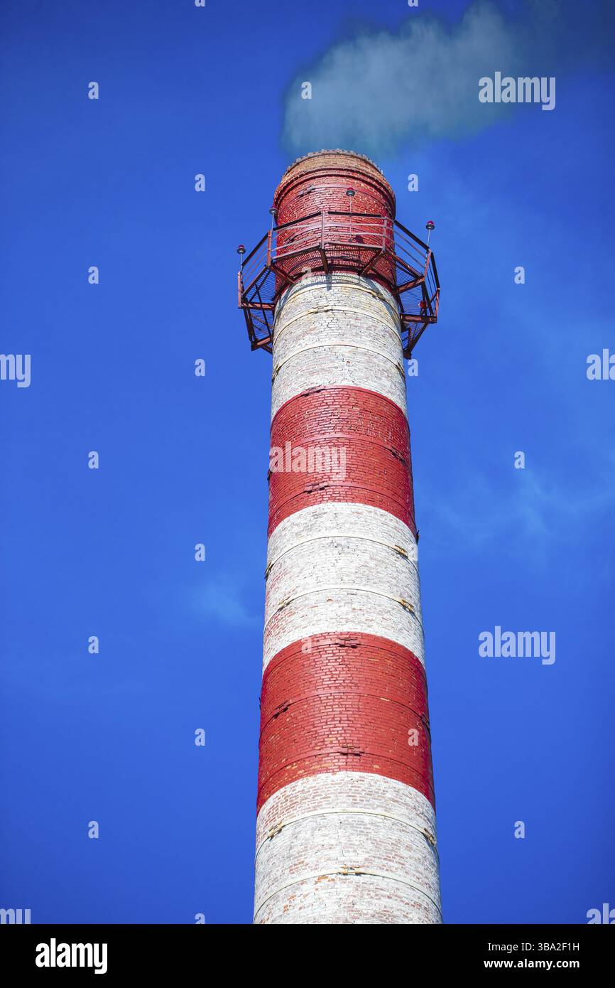 Vertical factory chimney with smoke Stock Photo - Alamy
