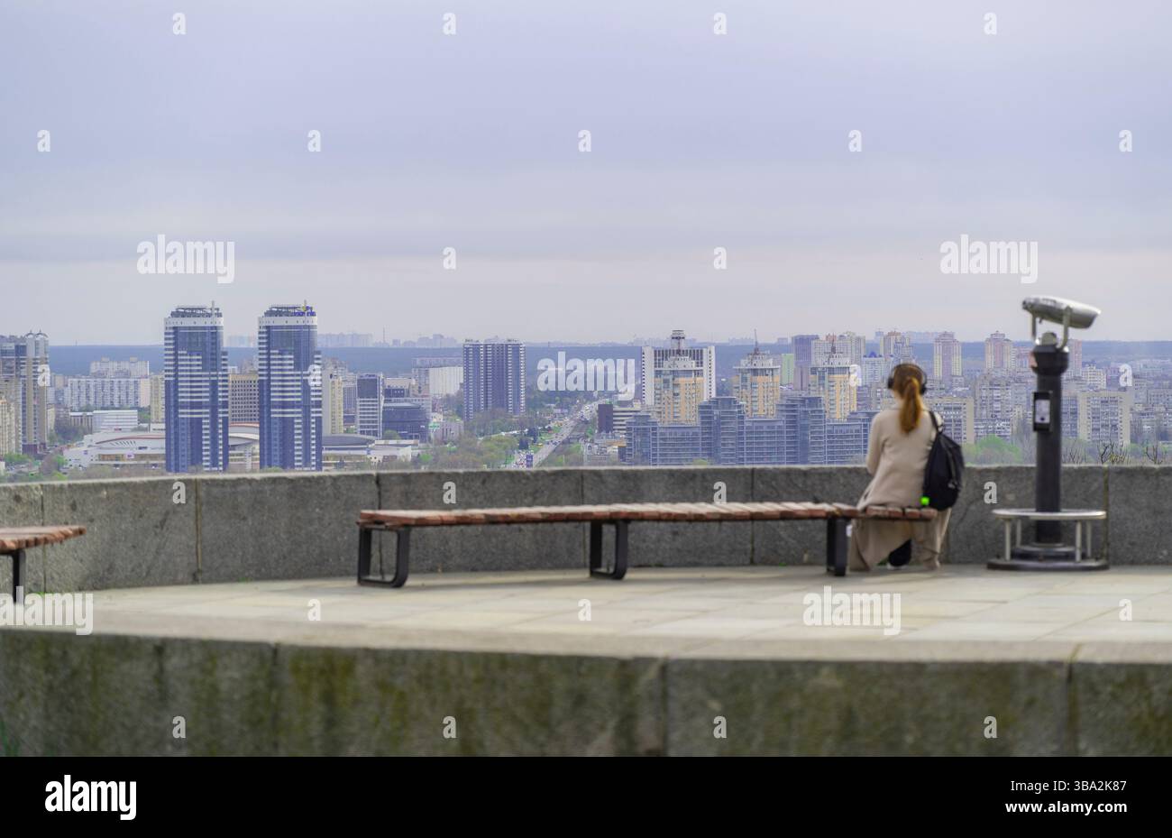 Kyiv, Ukraine - 28th April, 2025: Young woman sitting on a bench ...
