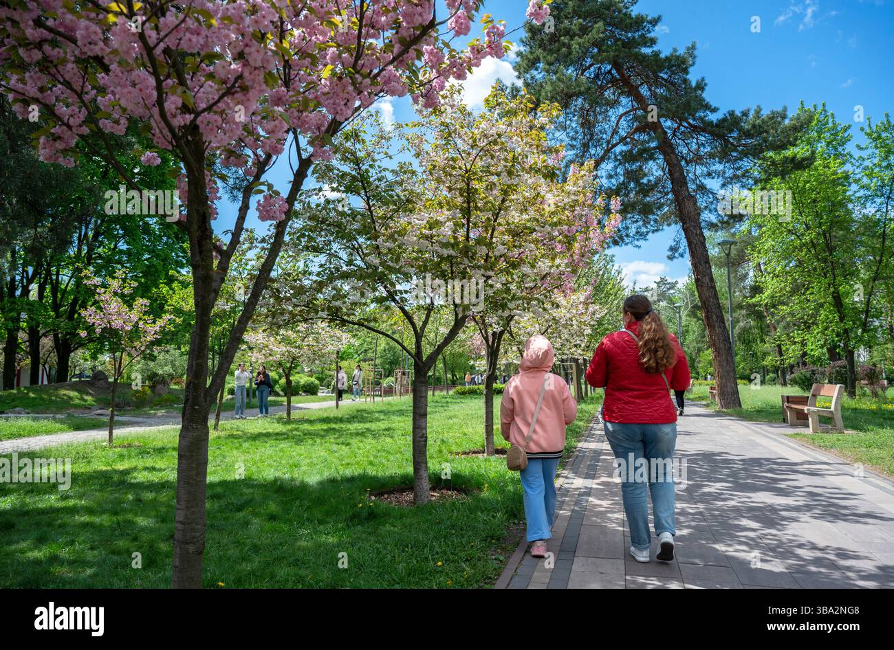 Kyiv, Ukraine - 28th April, 2025: Two tourists are walking on a paved ...