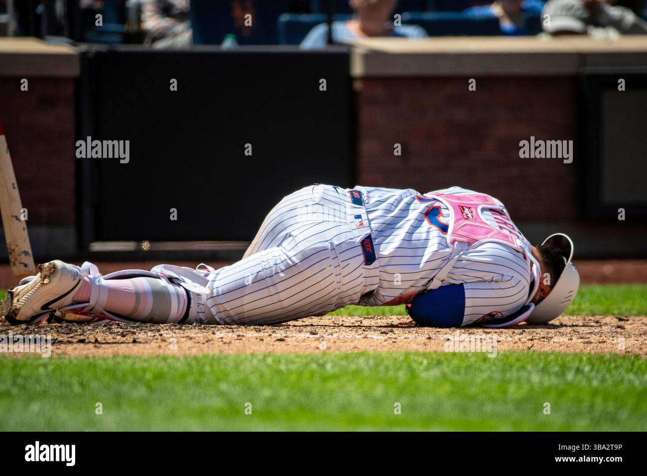 New York Mets catcher Luis Torrens falls to the ground after getting ...