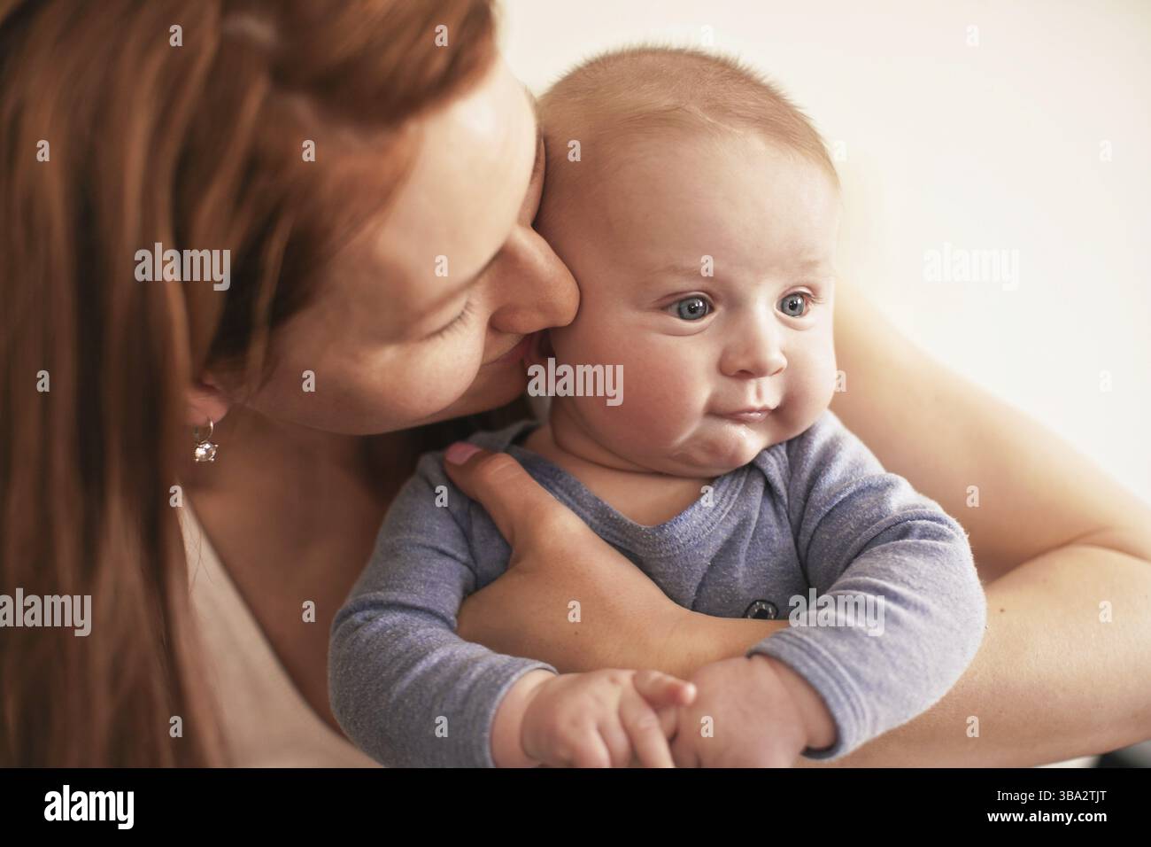 Woman lovingly holding baby hi-res stock photography and images - Alamy
