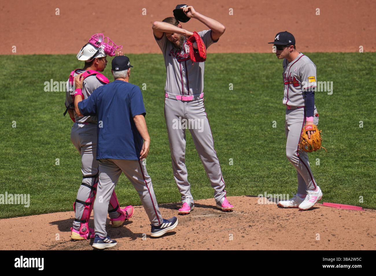 Atlanta Braves pitcher Chris Sale, center, gets a visit from pitching ...