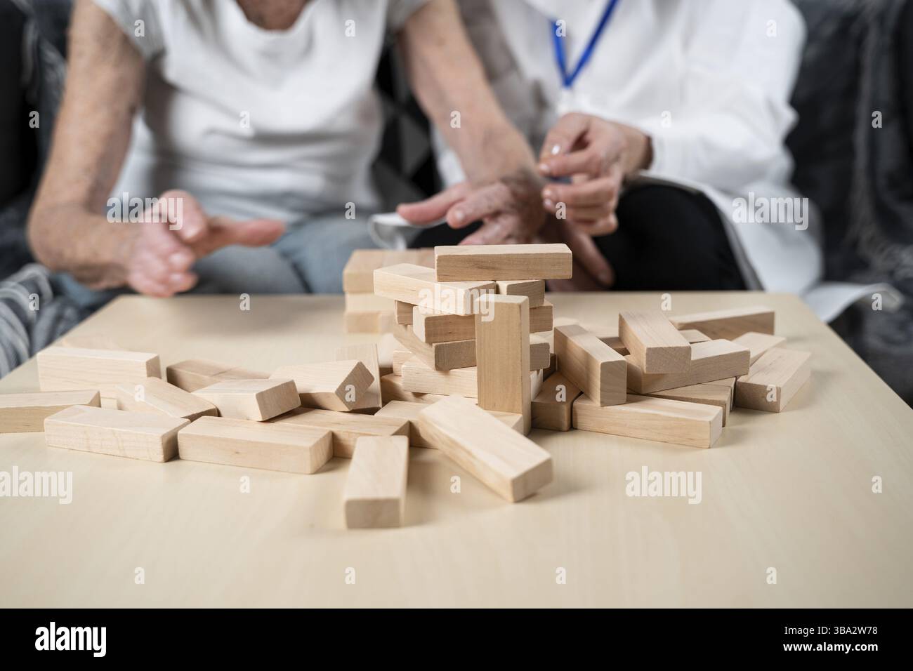 Dementia therapy in playful way, training fingers and fine motor skills, build wooden blocks ...