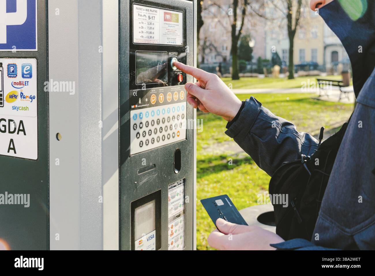 Man pays for parking with a credit card with NFS technology. Easy ...