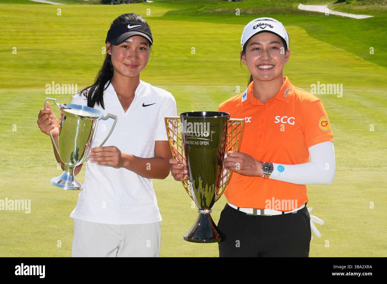 Jeeno Thitikul, of Thailand, right, and top amateur Aphrodite Deng, hold their trophies after ...