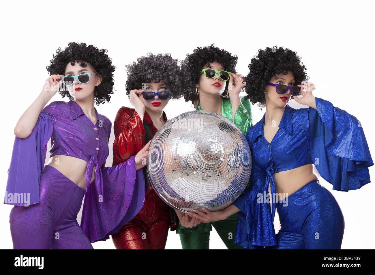 Group of funny girls in disco style, with disco ball, halloween party ...