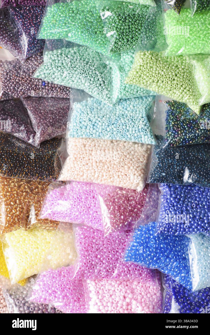 Colorfull glass beads batches in plastic bags for beadwork in craft ...