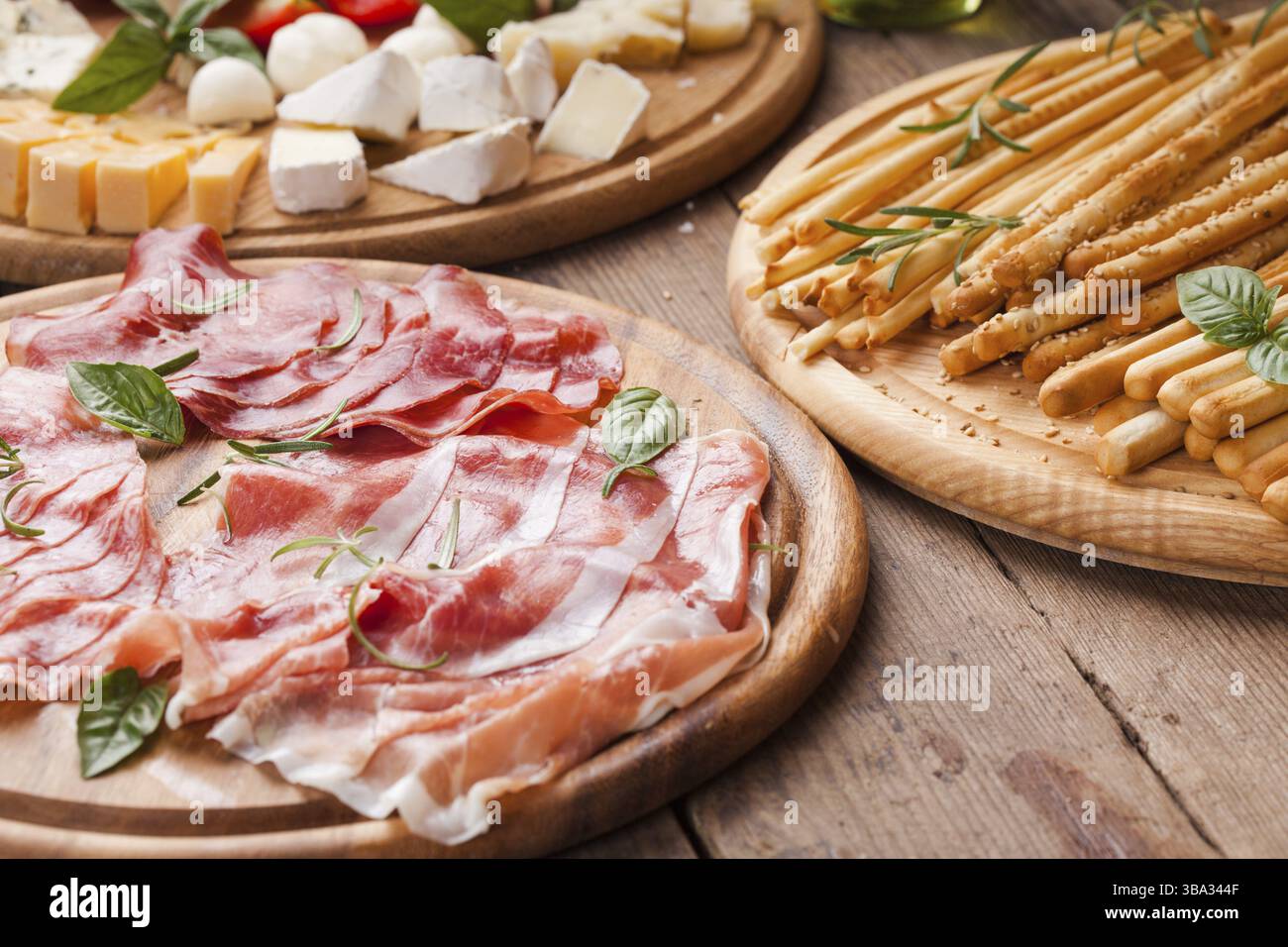 Italian appetizer - various types of ham, cheese and grissini Stock ...