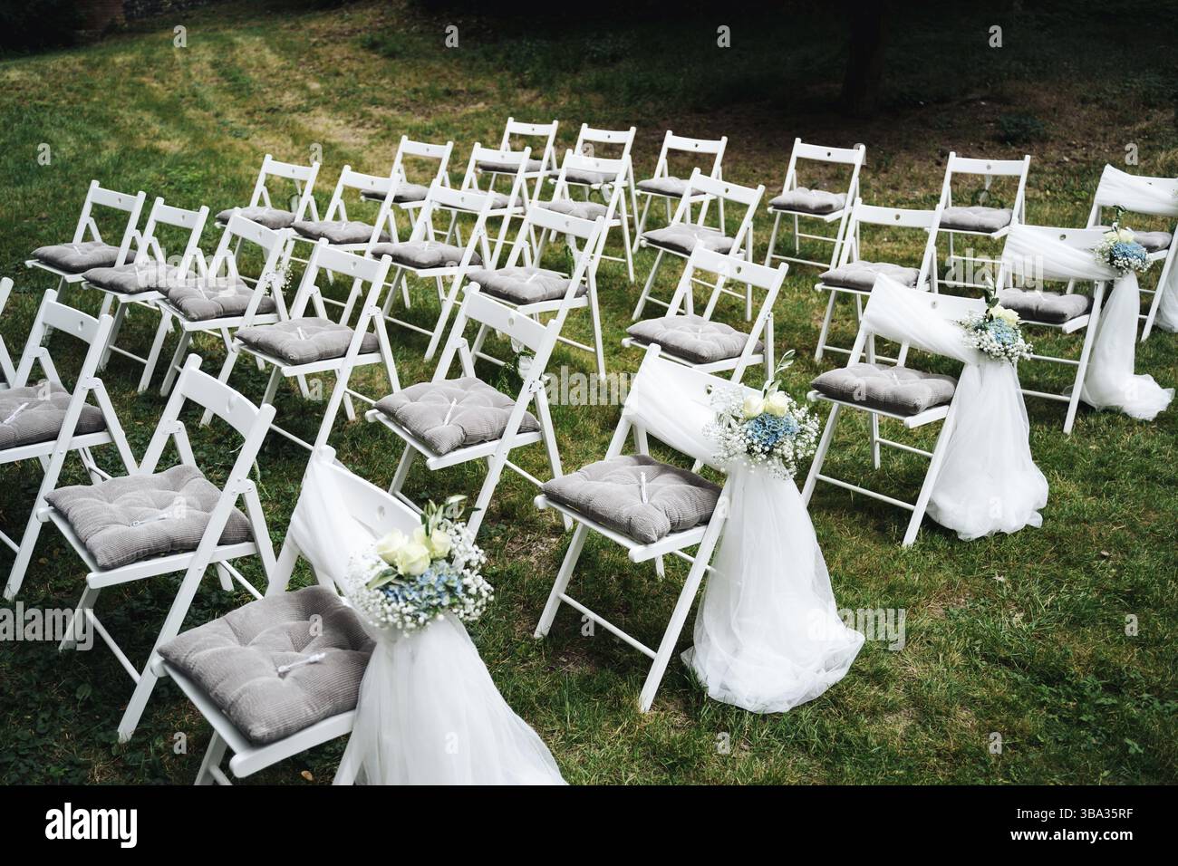 Photo of an empty wedding chairs in the garden Stock Photo - Alamy