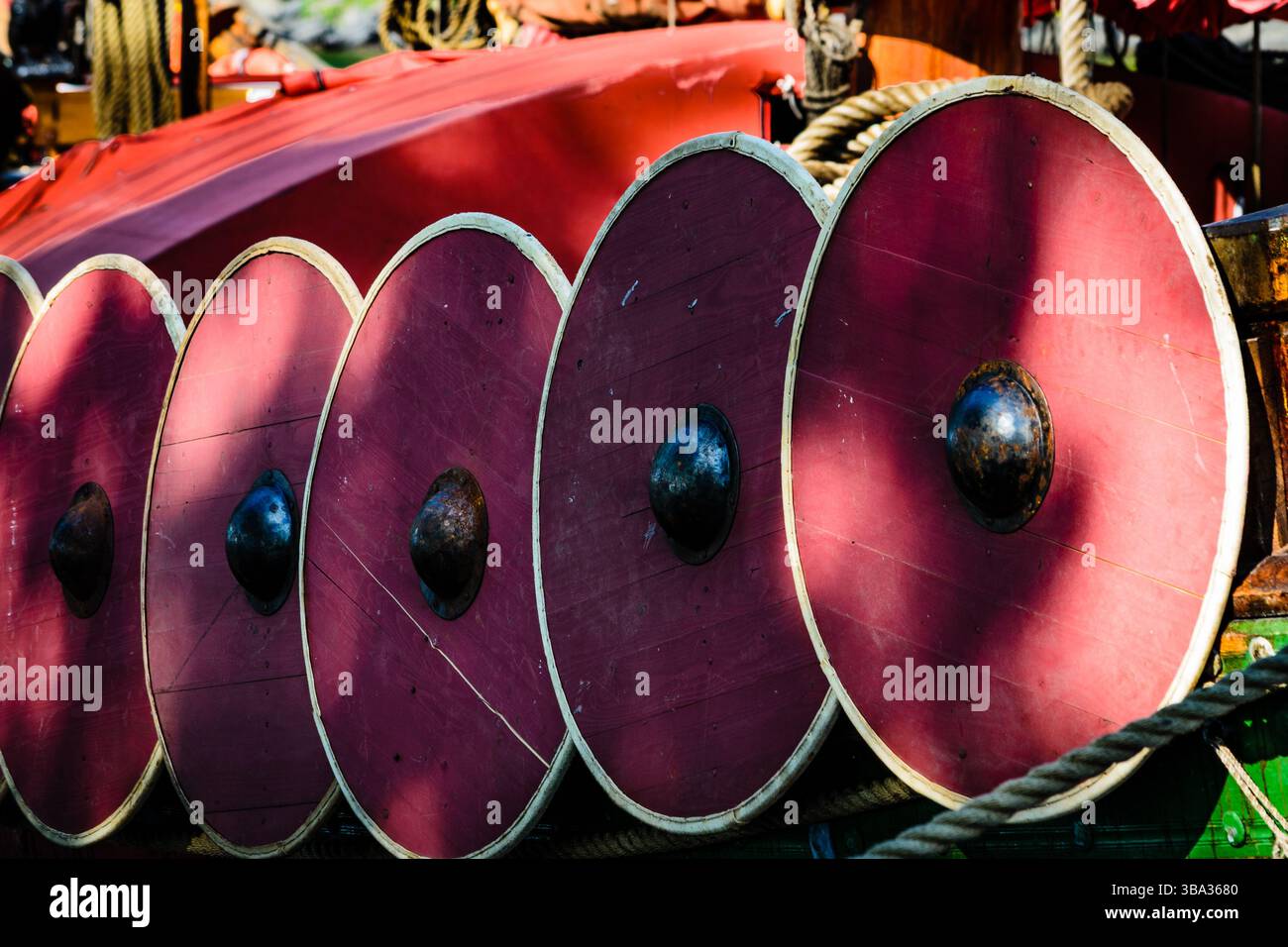 Red Wooden Replica Viking Shields lined up on the edge of a viking ship ...