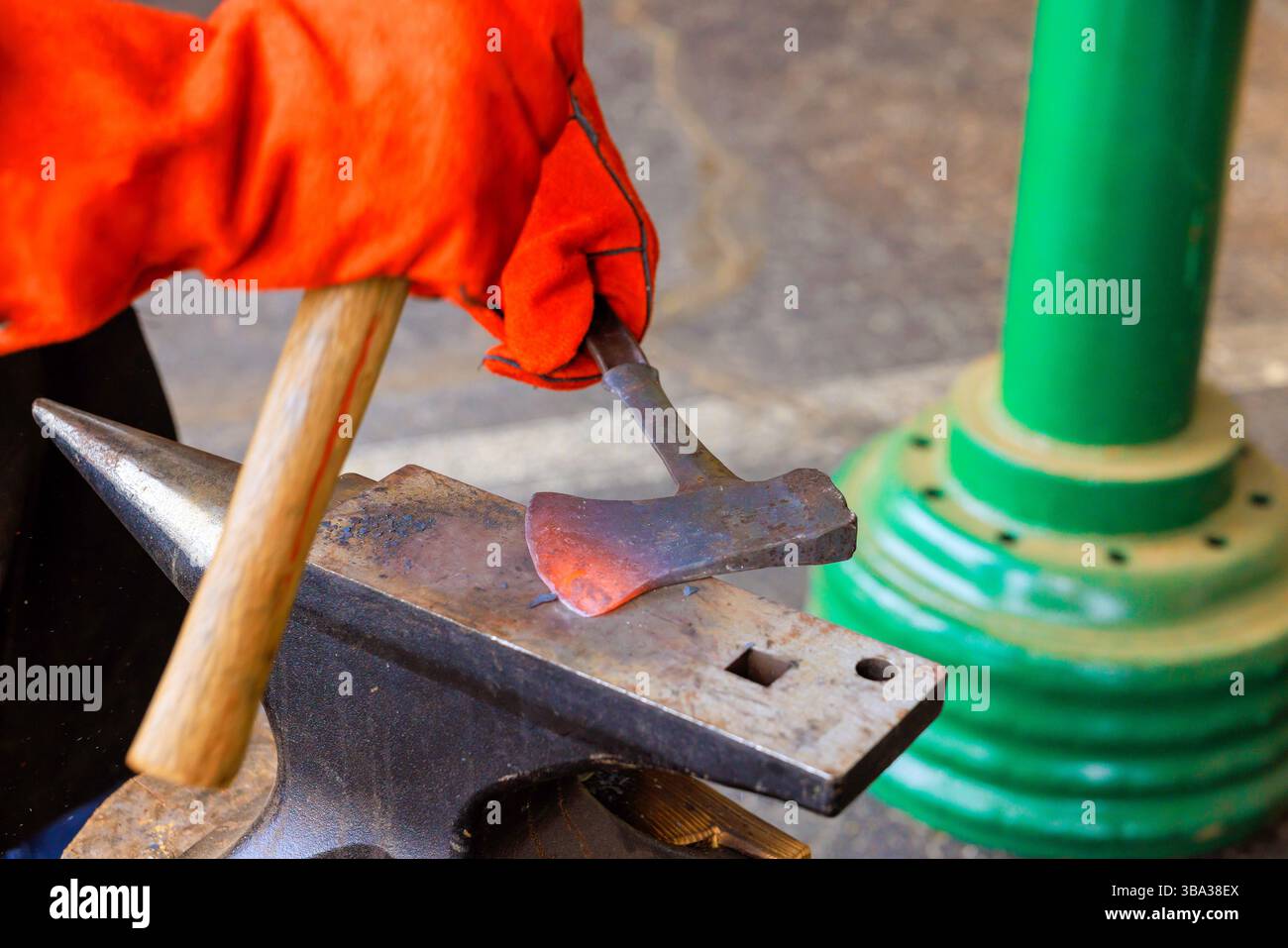 Artisan shapes glowing axe making hi-res stock photography and images ...