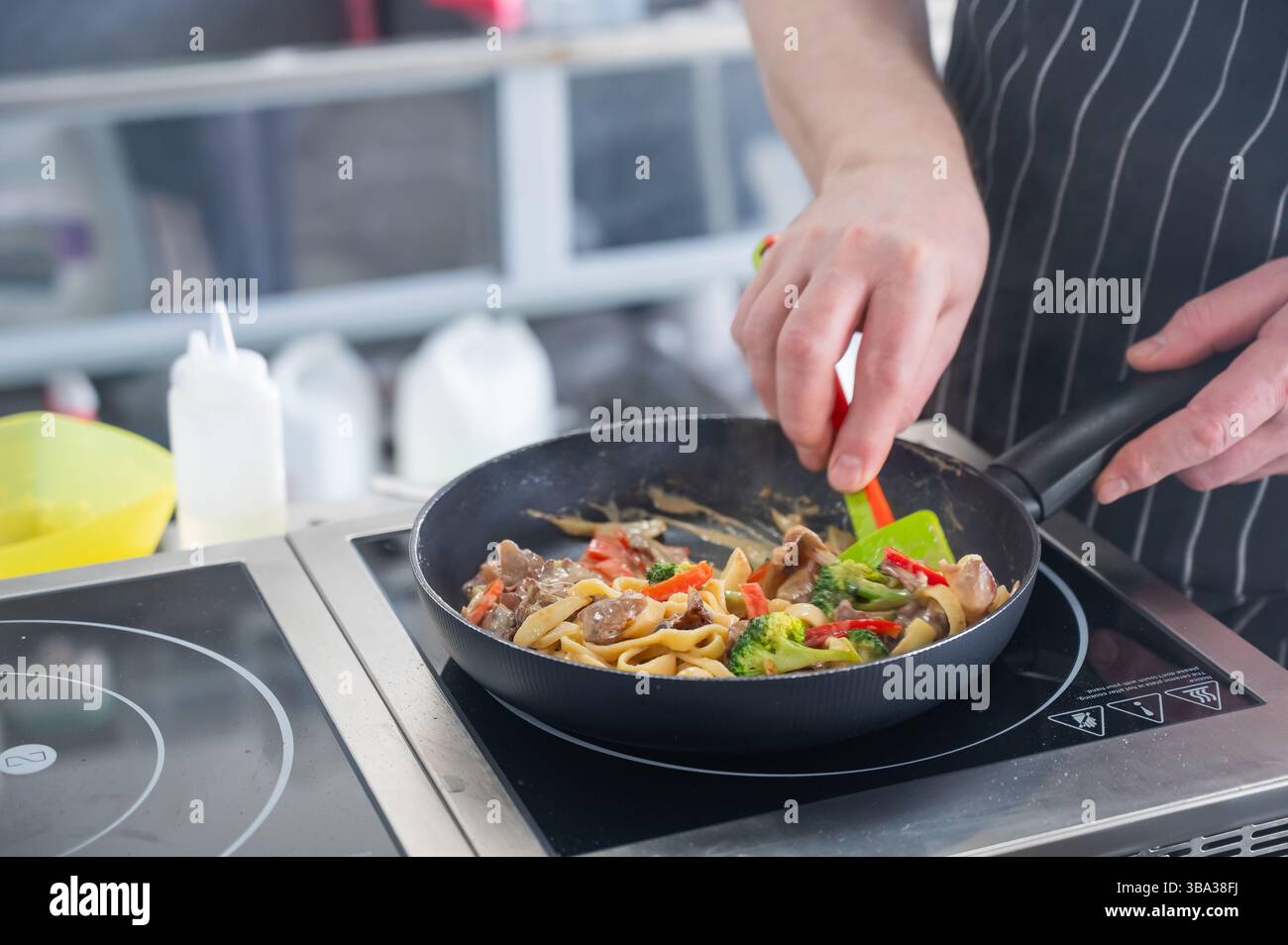 Chef cooks pasta in frying hi-res stock photography and images - Alamy
