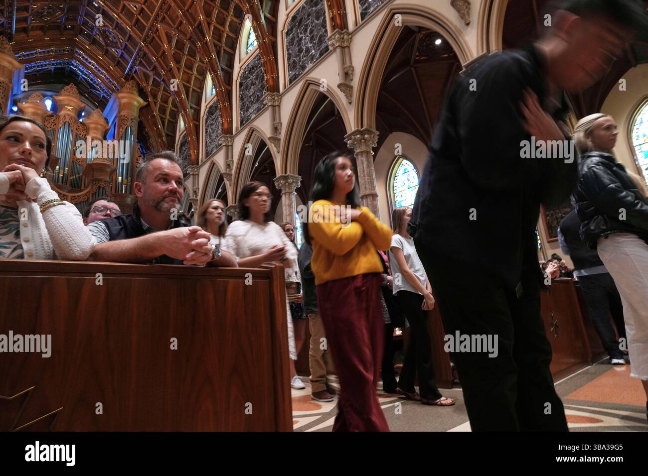 People line up for communion during a mass at Holy Name Cathedral in ...