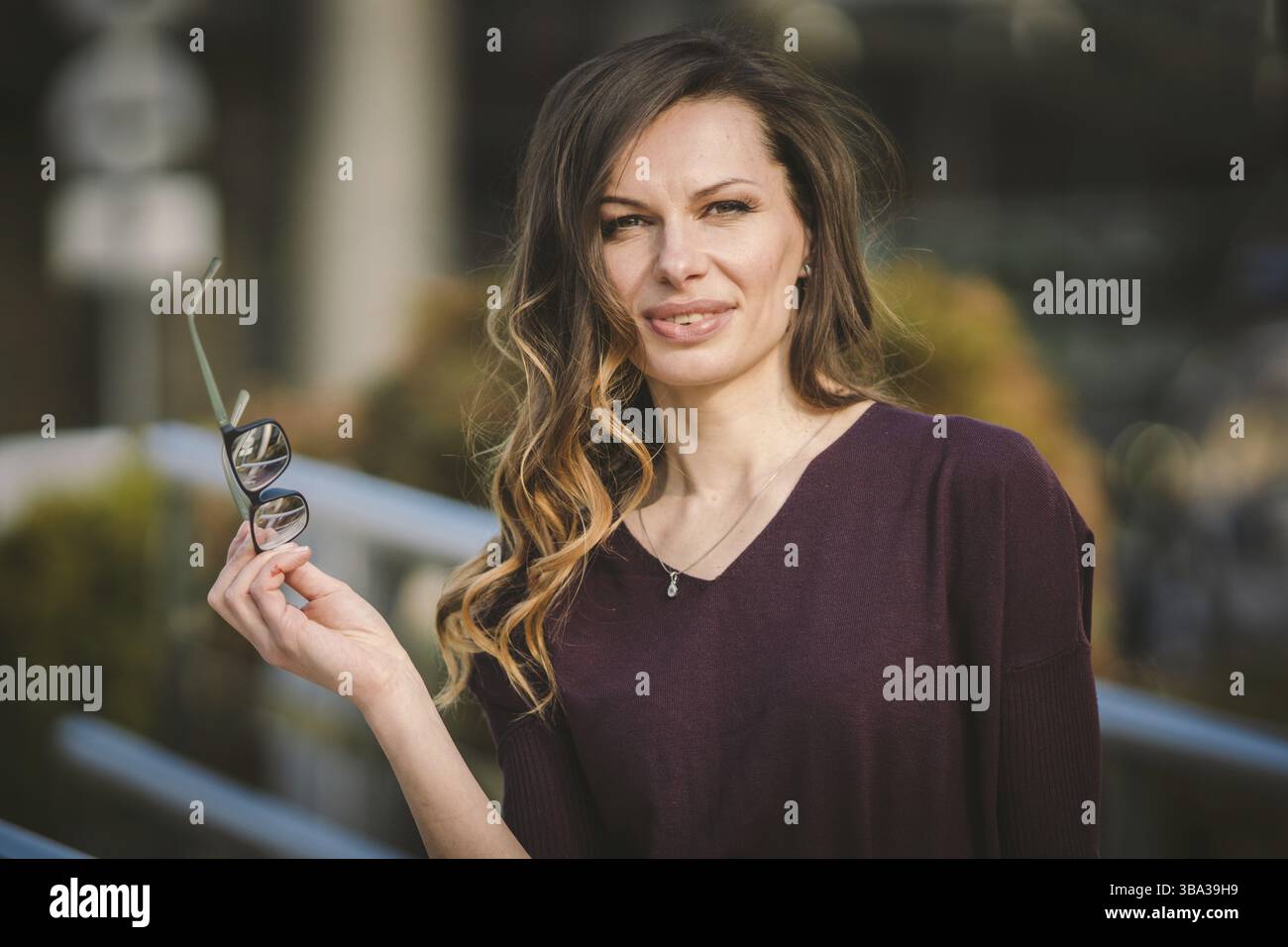 Caucasian adult lady woman in glasses posing near office building ...
