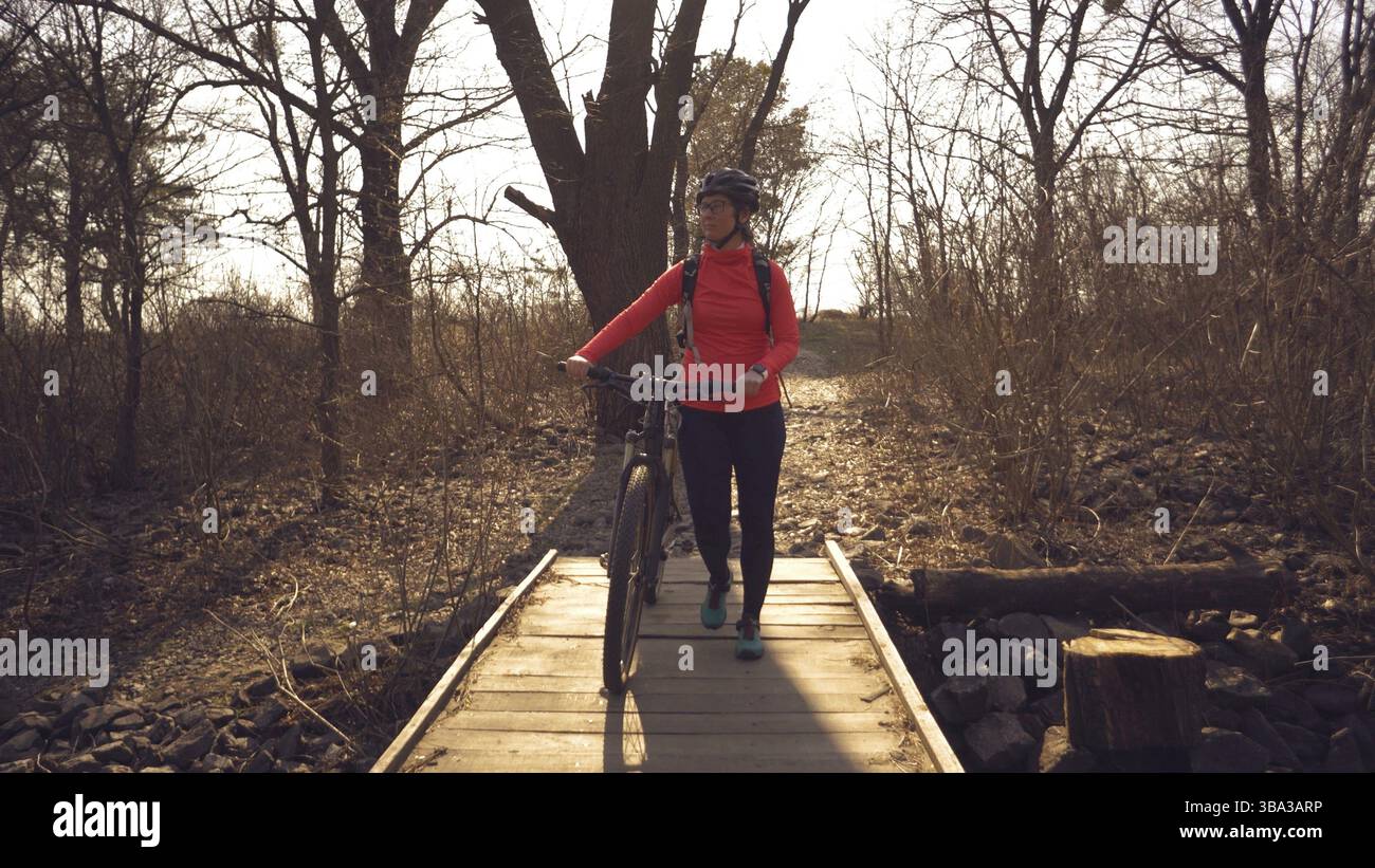 Athlete bicyclist Caucasian woman in sportswear and helmet crosses on ...