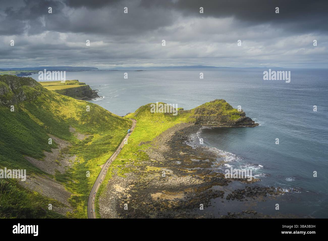 Tourists and bus on the Giants Causeway trail, seen from top of the ...