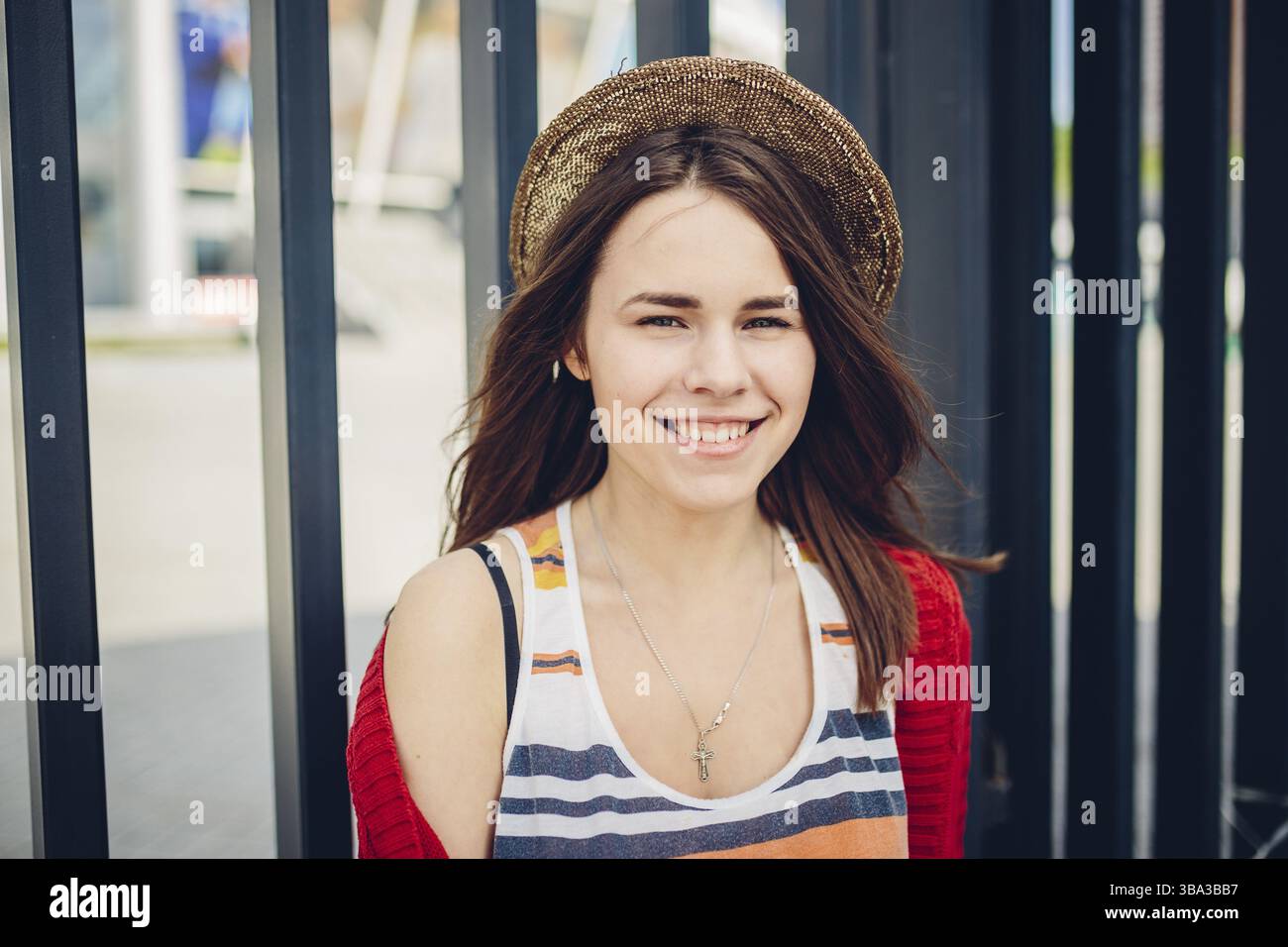 Portrait of a beautiful, stylish young Caucasian woman with a toothy ...