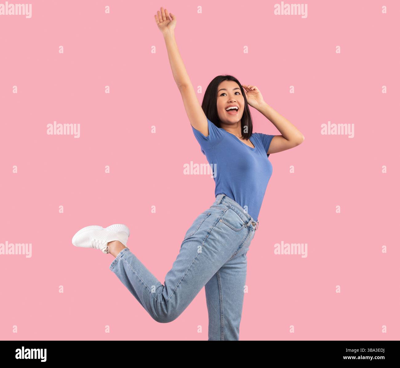 Happy young asian lady jumping at studio Stock Photo - Alamy