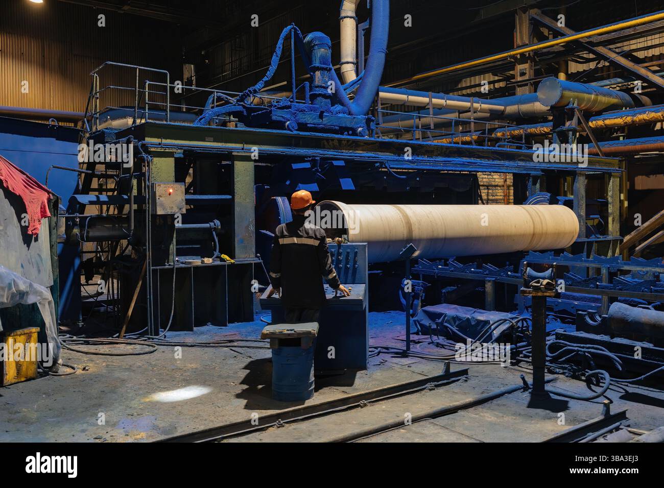 Factory engineer operates pipe painting automatic machine Stock Photo ...